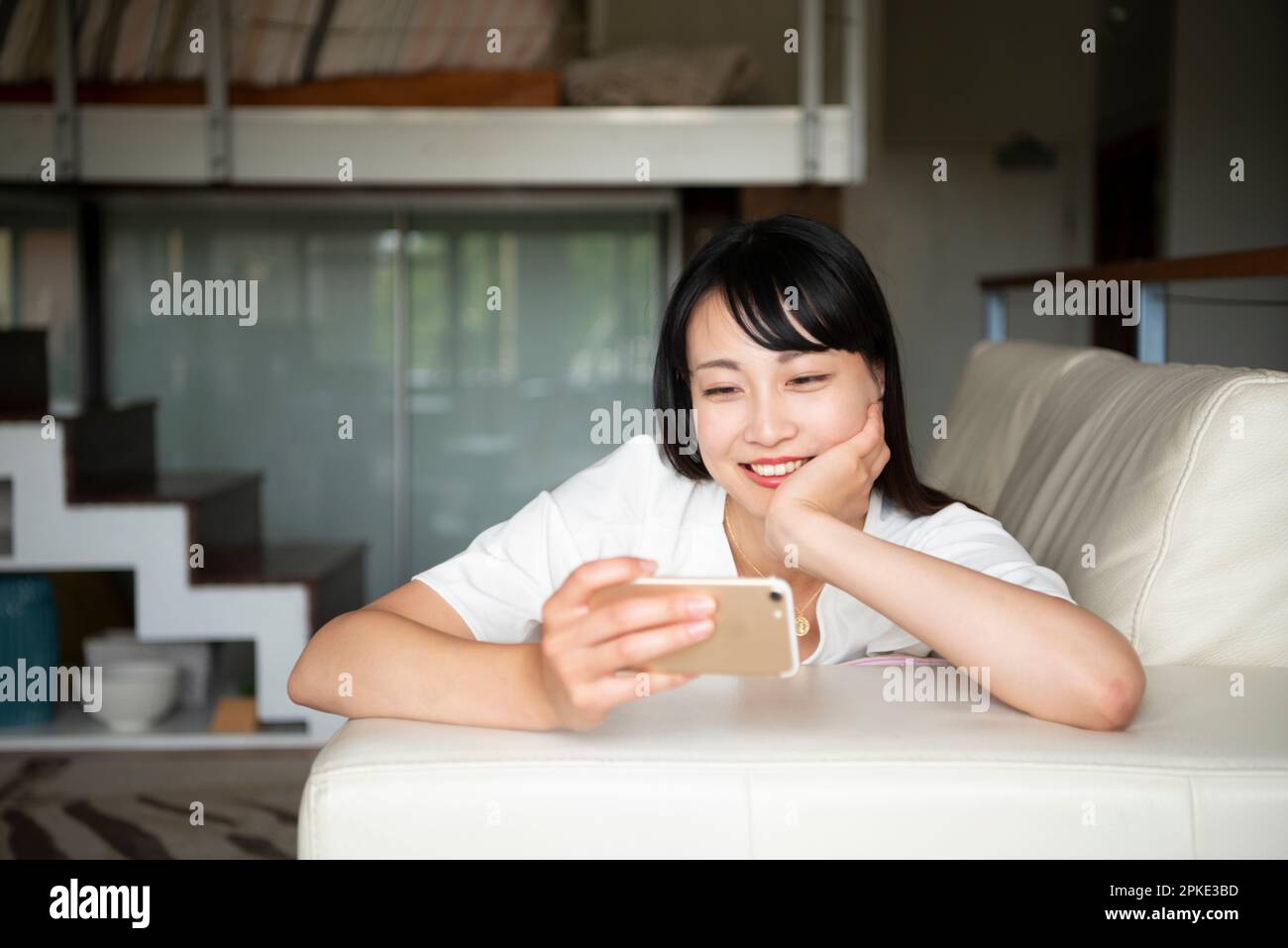 Female watching mobile hi-res stock photography and images - Alamy