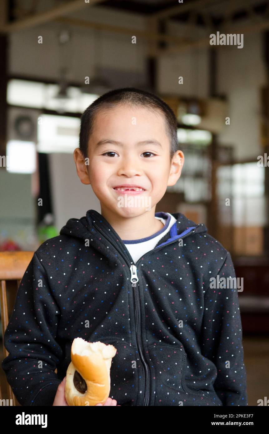 Toothless Boy Eating Bread Stock Photo - Alamy