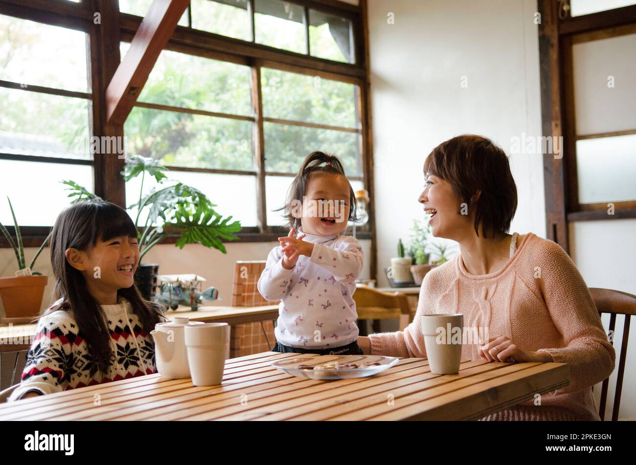 Parent and child eating a snack Stock Photo - Alamy