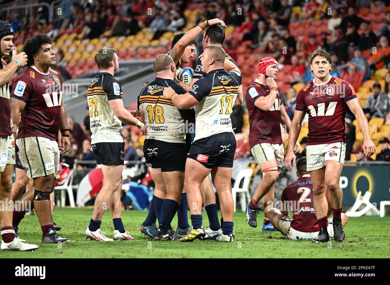 Nick Frost (centre) of the Brumbies celebrates scoring a try with team ...