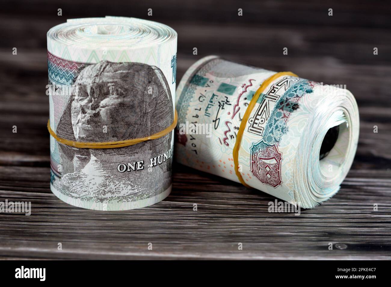 100 EGP LE one hundred Egyptian pounds cash money bills rolled up with ...