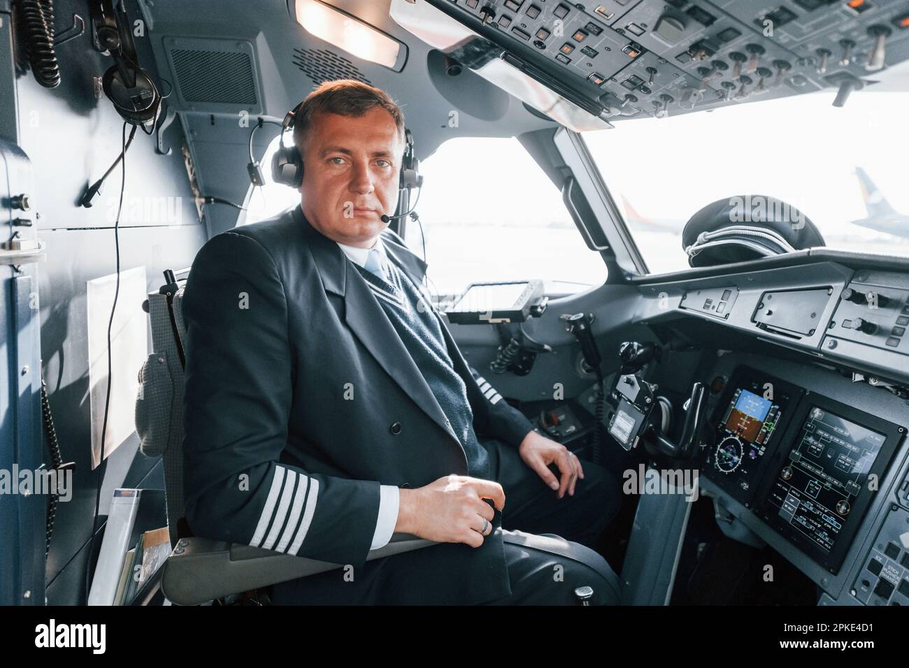 Side view. A professional pilot is in the cockpit. Conception of work ...