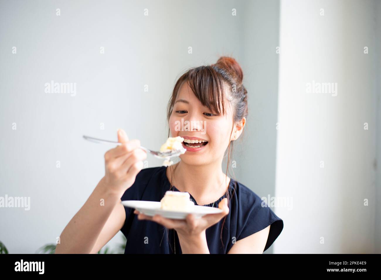 Woman eating cake Stock Photo - Alamy