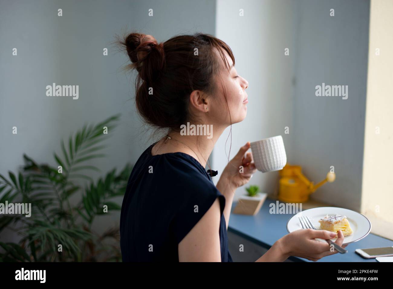 Woman tasting tea Stock Photo - Alamy
