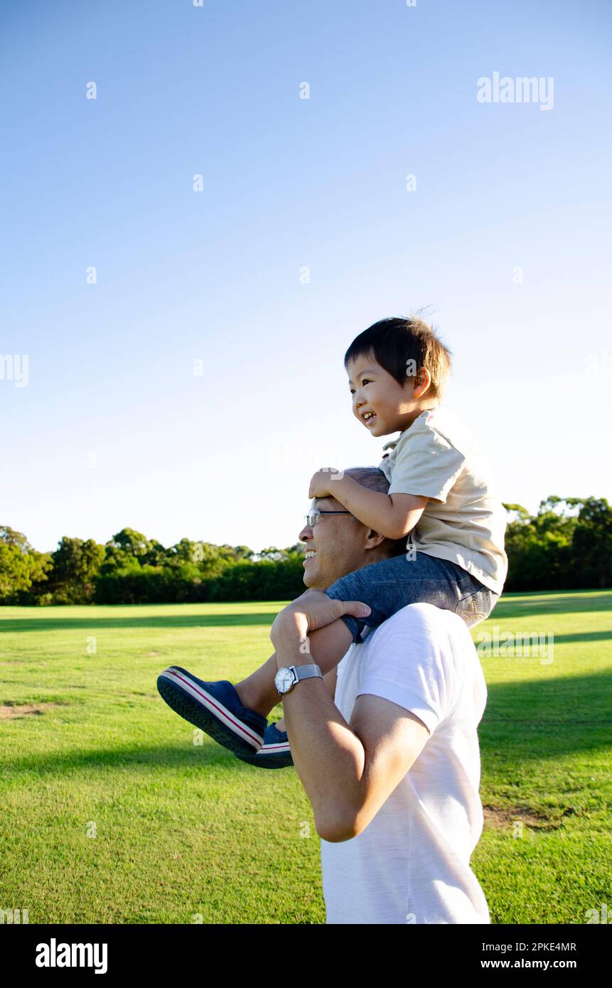 Parent and child laughing while riding on each other's shoulders Stock ...