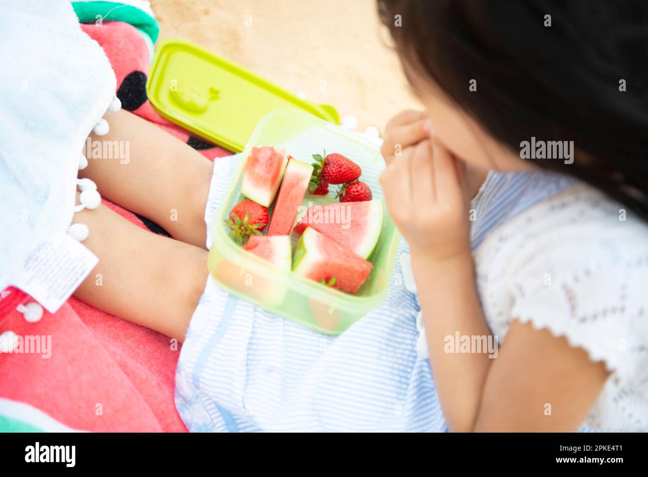 Girl with Tupperware with fruit on it Stock Photo - Alamy