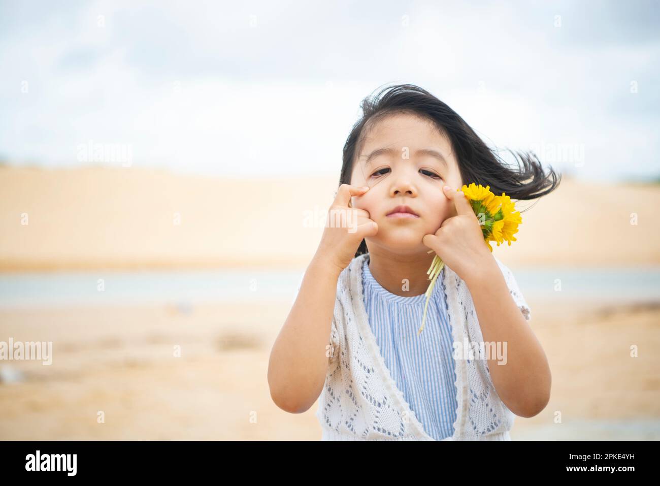 Girl doing the "ah-ha-boo" sign Stock Photo - Alamy