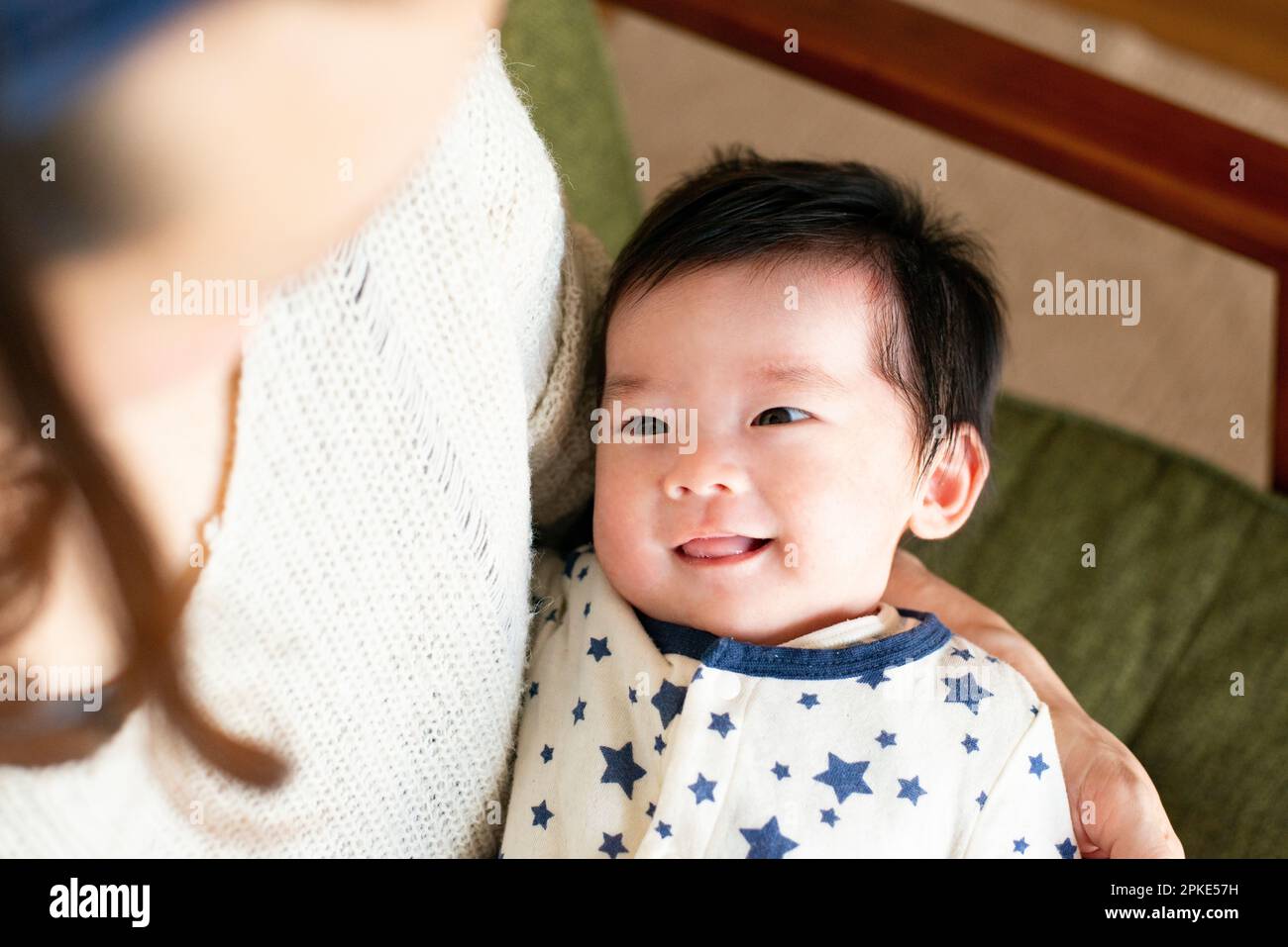 Laughing baby looking at mother Stock Photo - Alamy