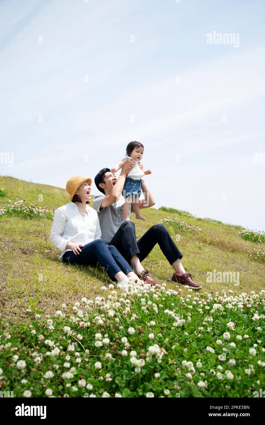 Family sitting on lawn Stock Photo - Alamy