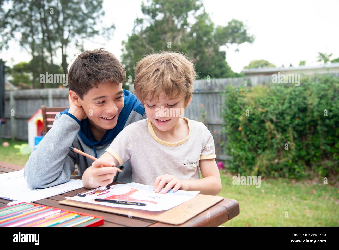 Brothers drawing together Stock Photo - Alamy