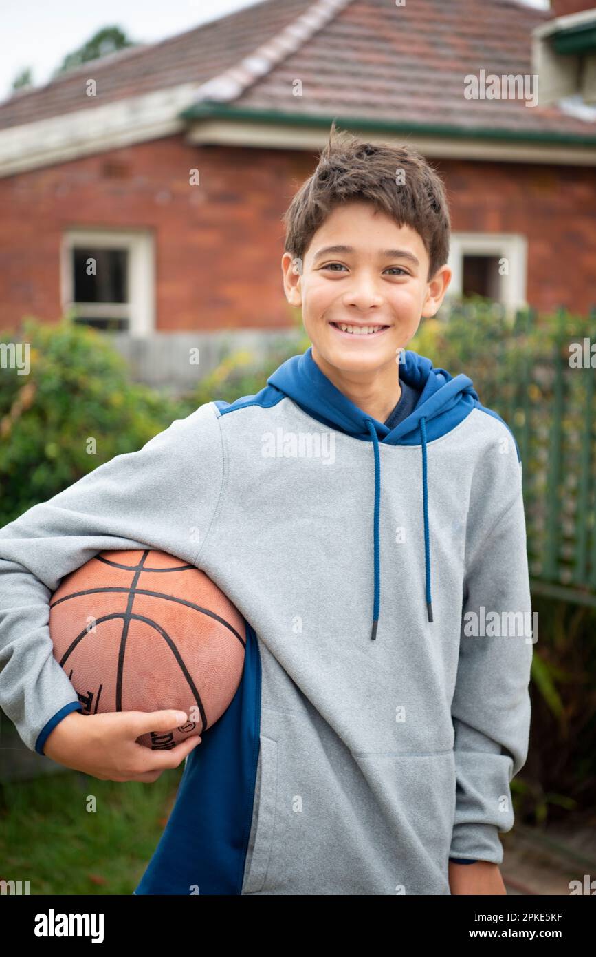 Boy laughing with basketball Stock Photo - Alamy