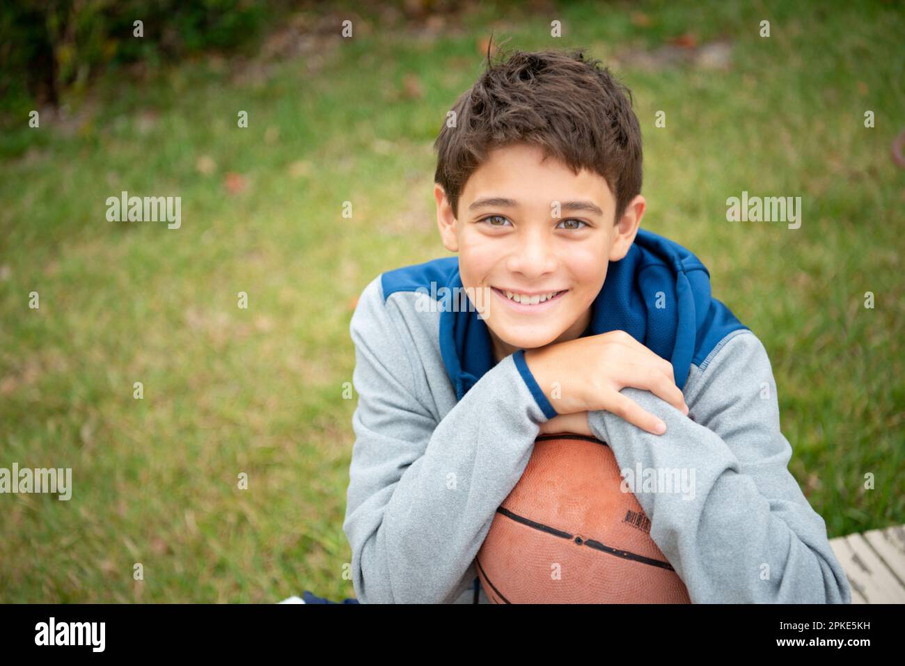 Boy laughing with basketball Stock Photo - Alamy