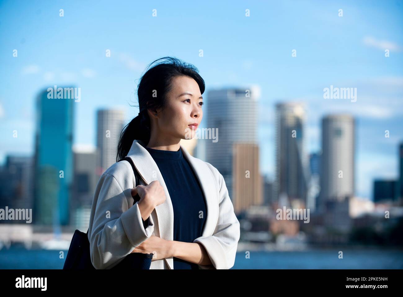 Woman staring into the distance in front of a group of buildings Stock ...