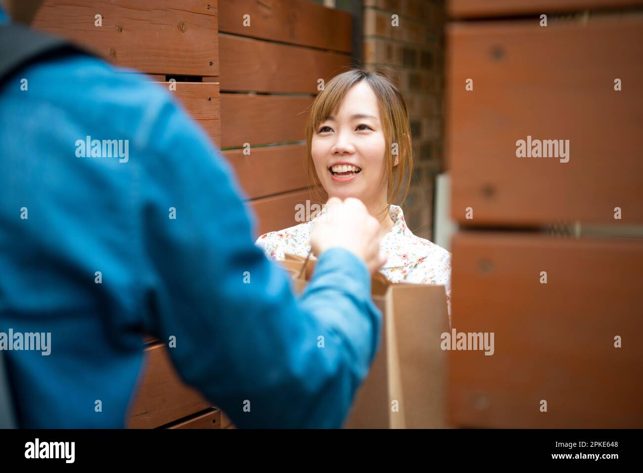 Receiving food delivery at front door hi-res stock photography and ...