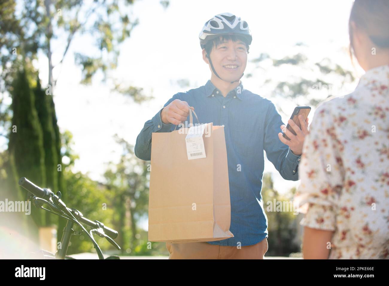Man and woman delivering food Stock Photo - Alamy