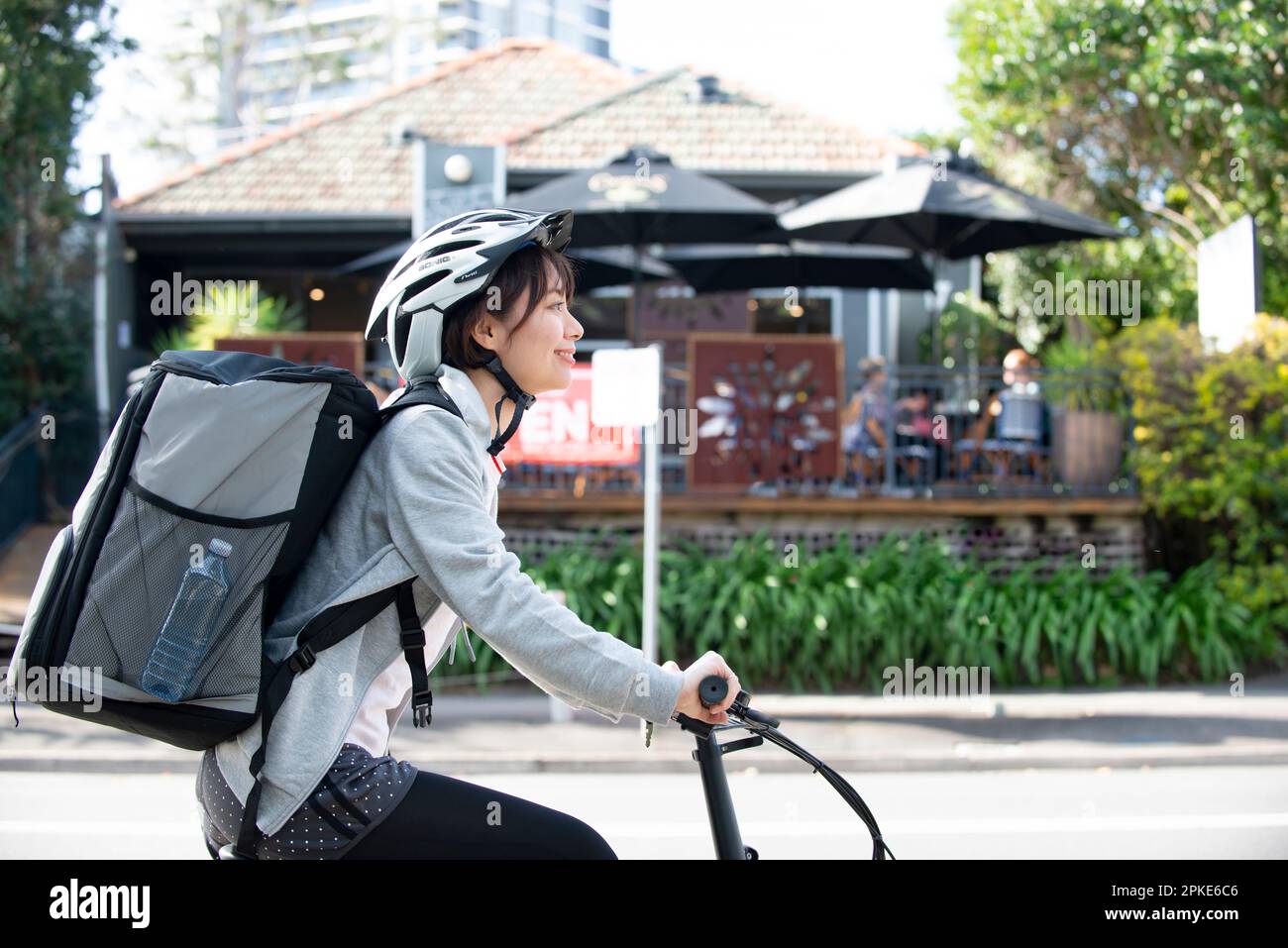 Food delivery man woman on bicycle Stock Photo - Alamy