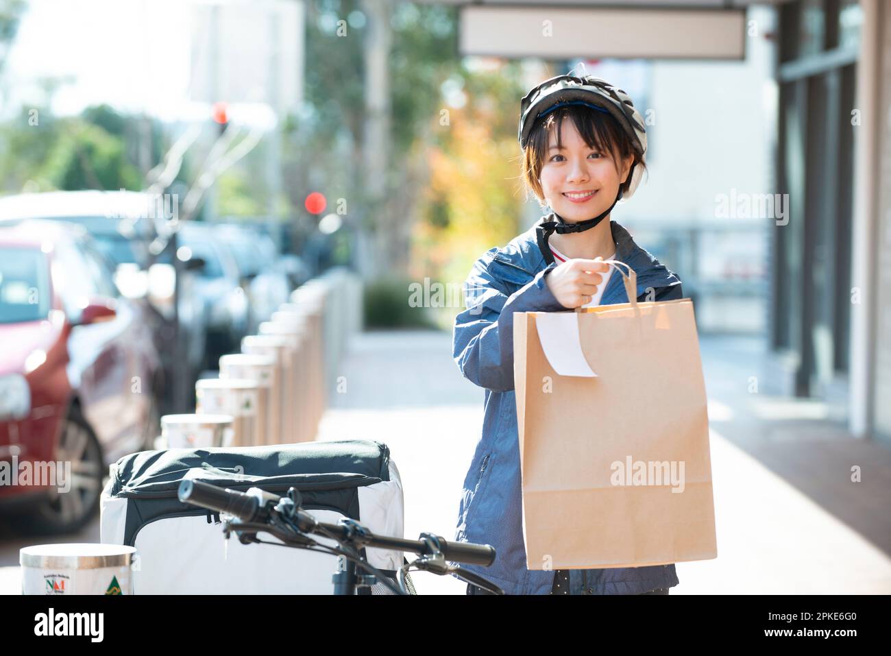 Delivery Woman Offering Delivery Goods Stock Photo - Alamy