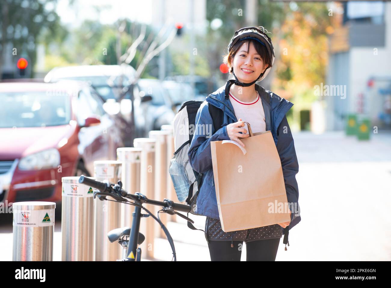 Delivery woman holding delivery goods Stock Photo - Alamy