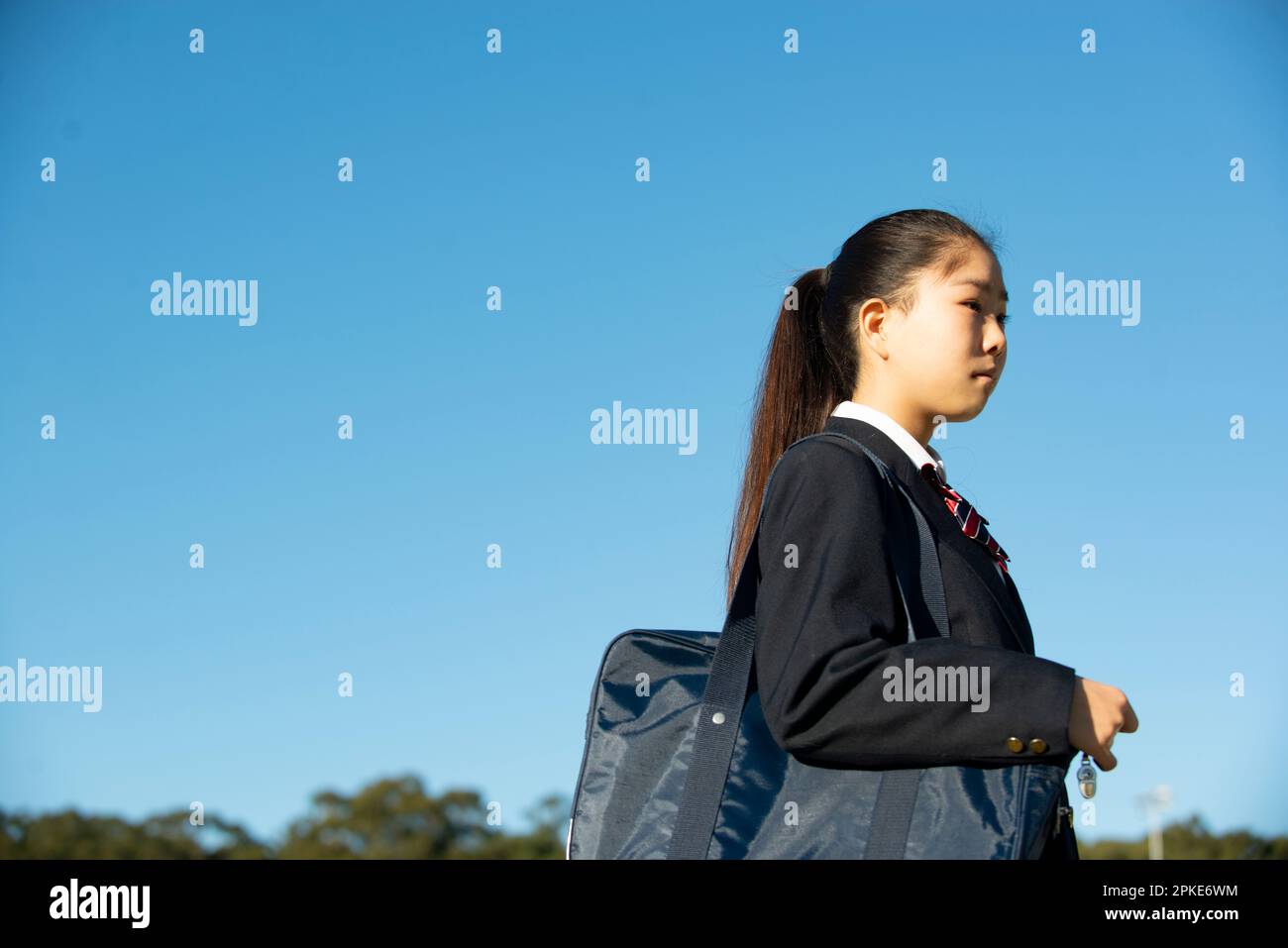 Female student in school uniform looking into the distance Stock Photo ...