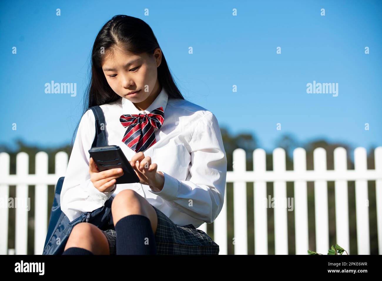 School uniform sitting hi-res stock photography and images - Alamy