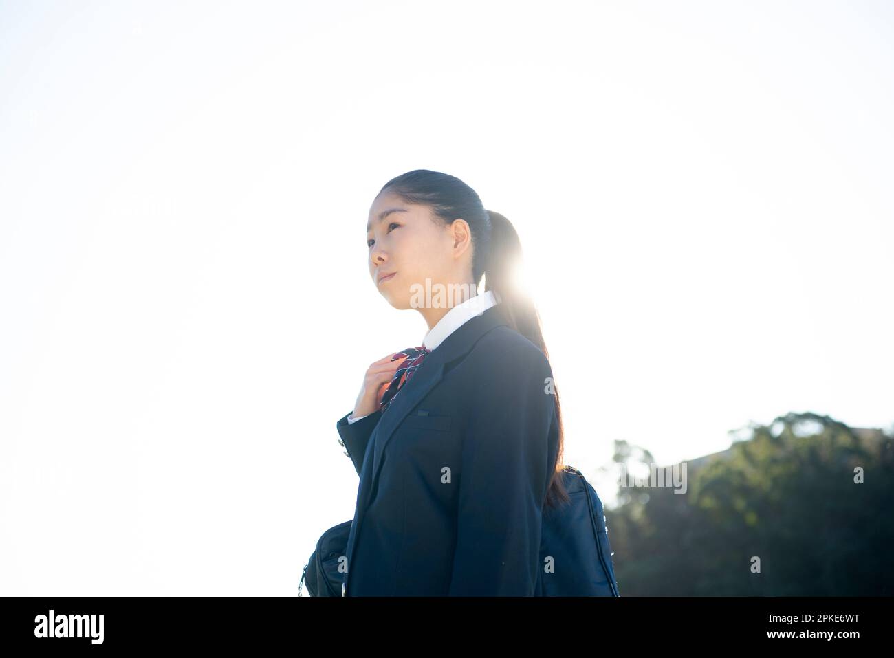 Female student in school uniform looking into the distance Stock Photo ...