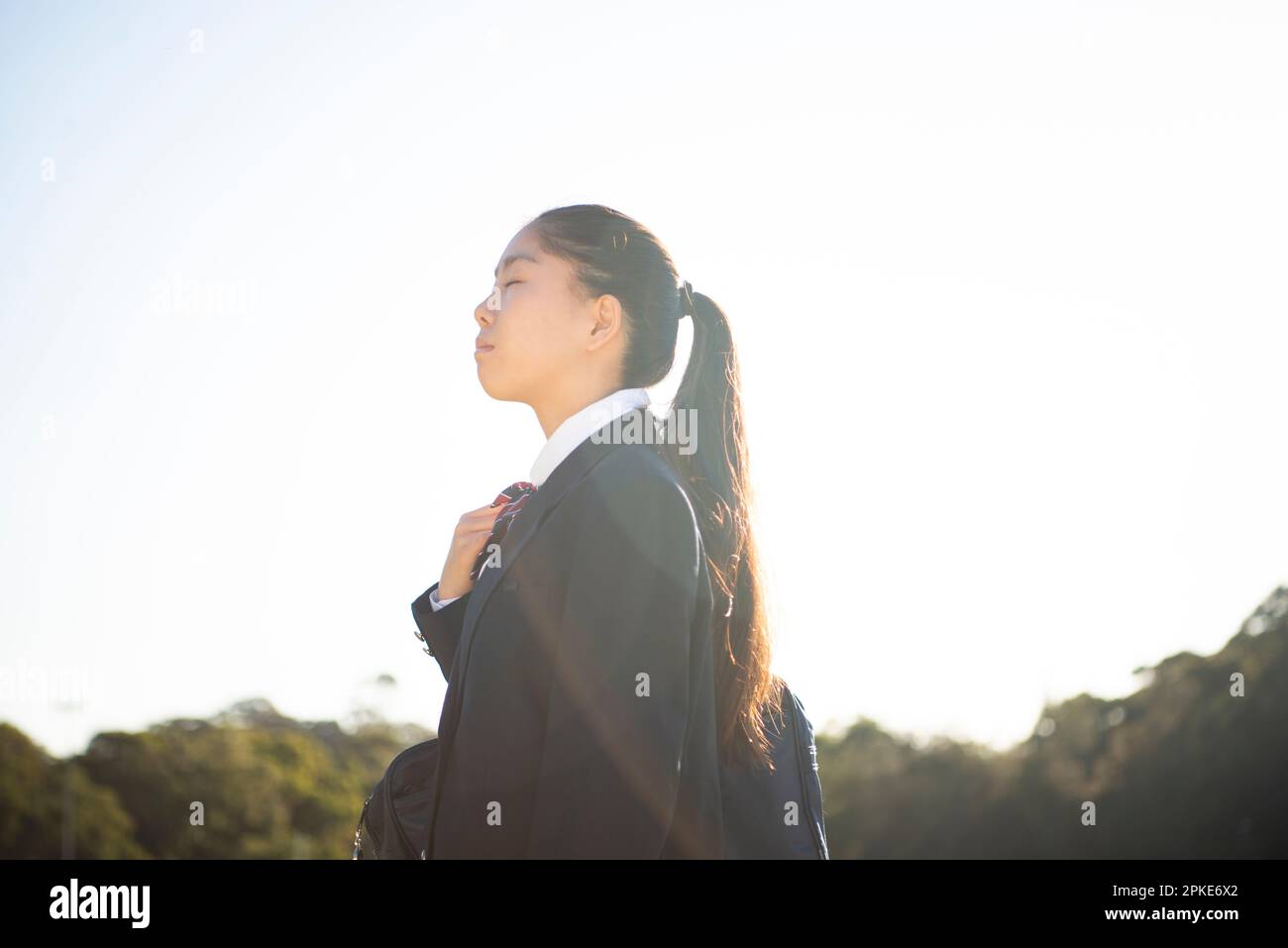 Female student in school uniform with her eyes closed Stock Photo - Alamy