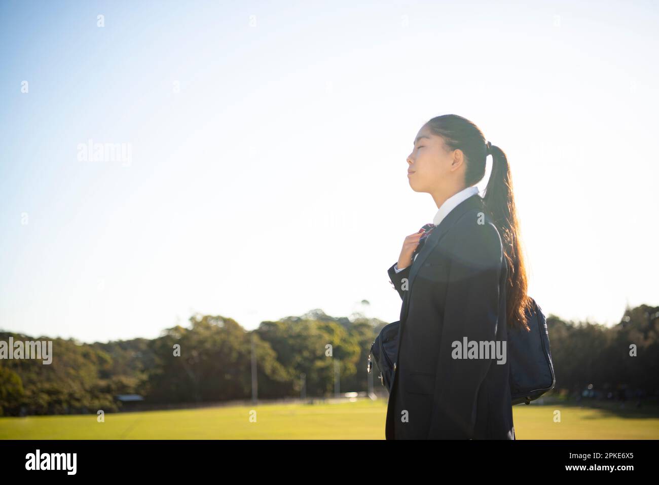 Female student in school uniform with her eyes closed Stock Photo - Alamy