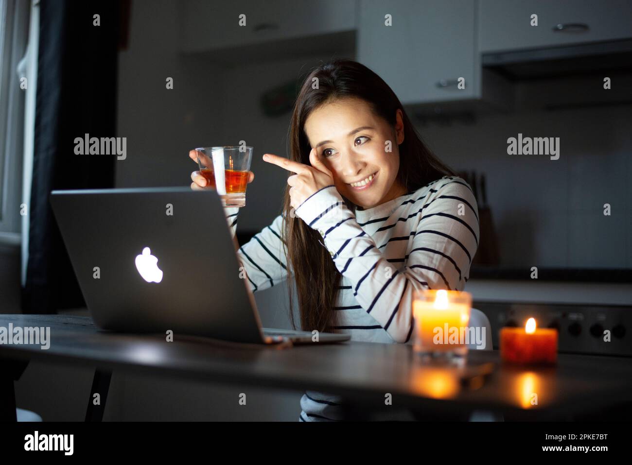 Woman having a remote drink using a computer Stock Photo - Alamy