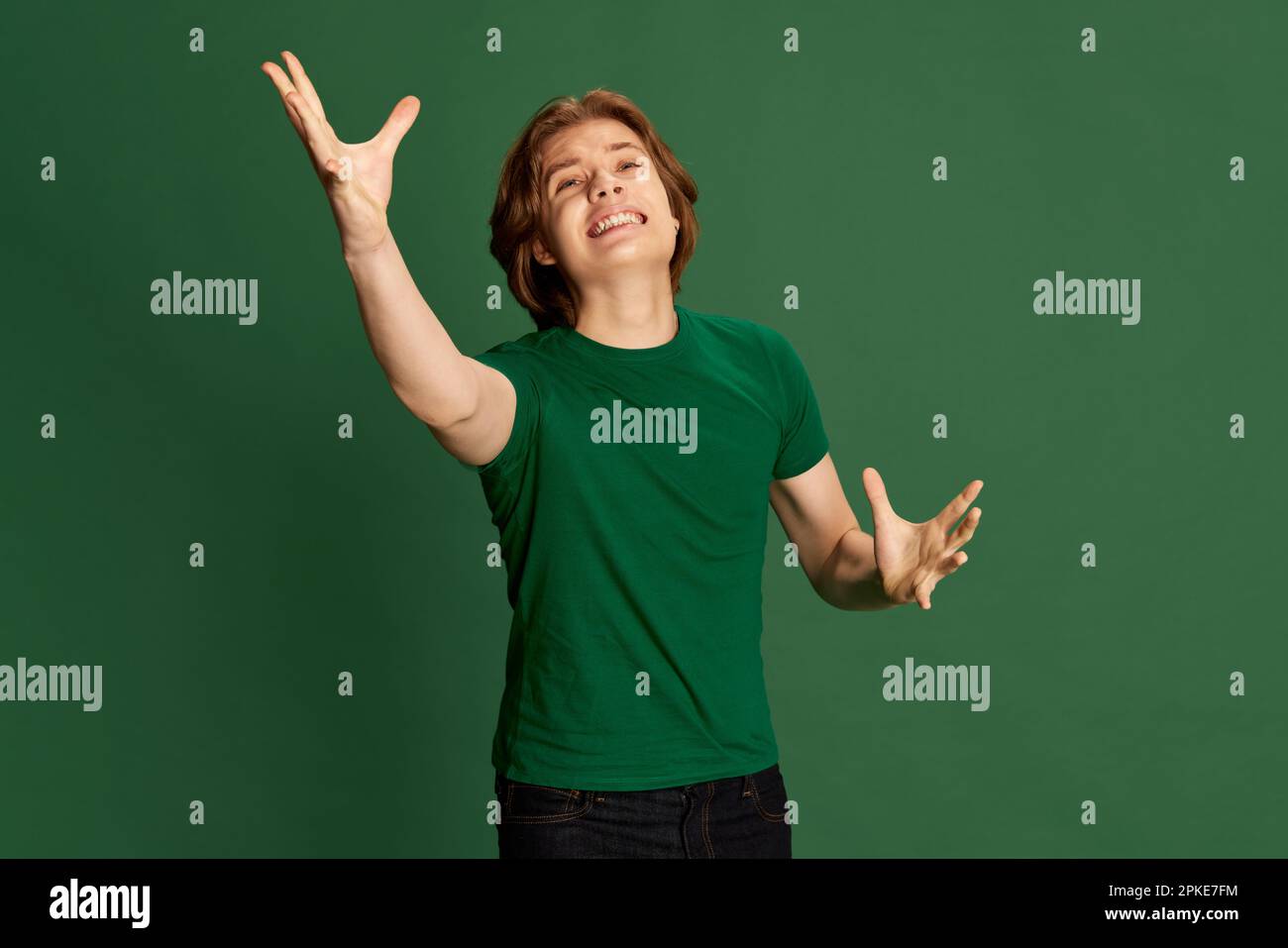 Good-looking young man, guy trying to catch something with tense facial ...