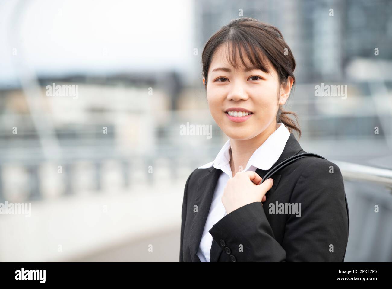 Woman in suit smiling Stock Photo - Alamy