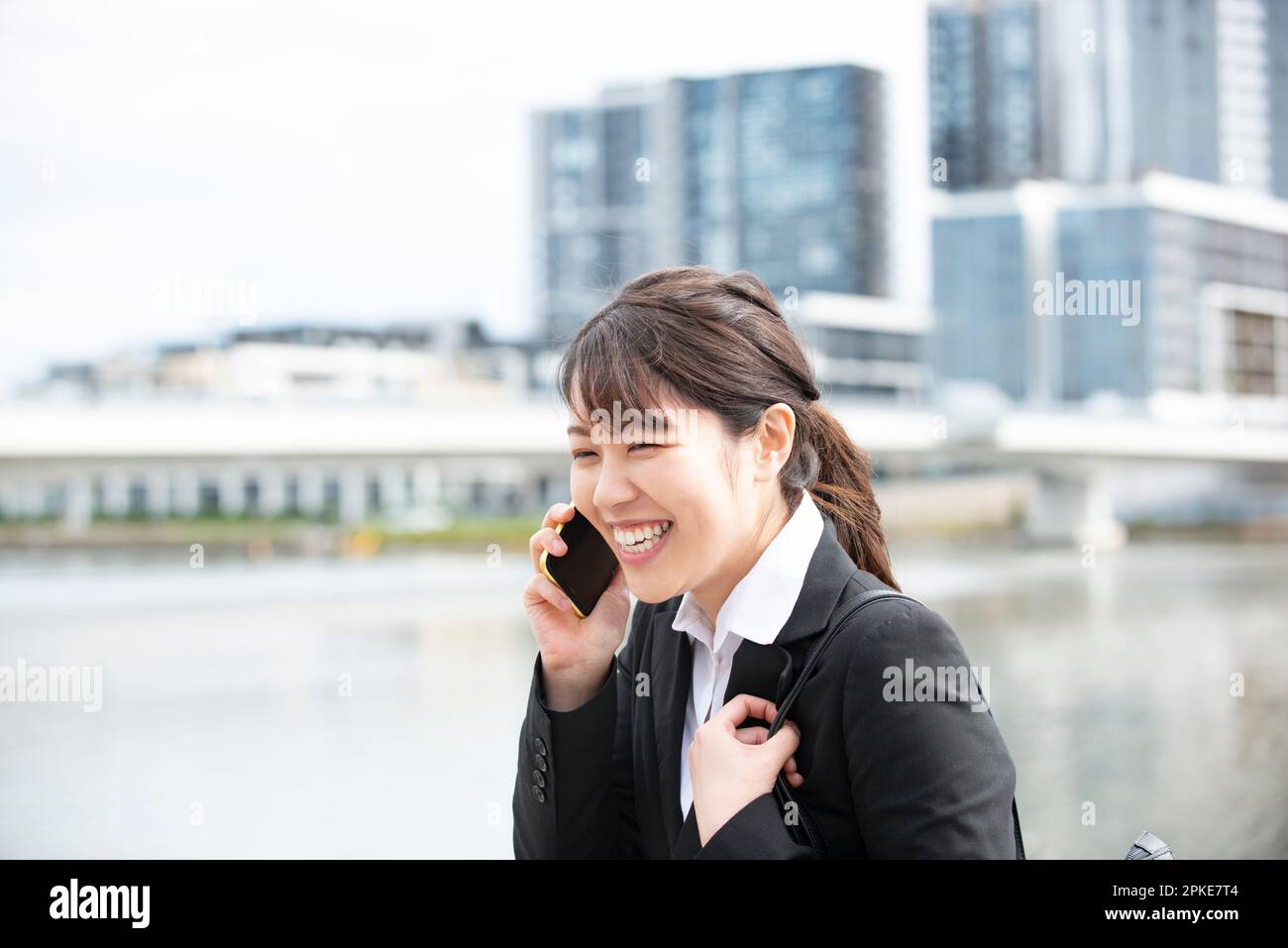 Young asian woman smile while talking on smartphone hi-res stock ...