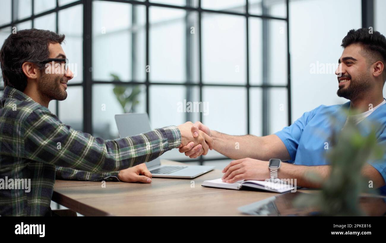 Doctor greeting patient handshake hi-res stock photography and images ...