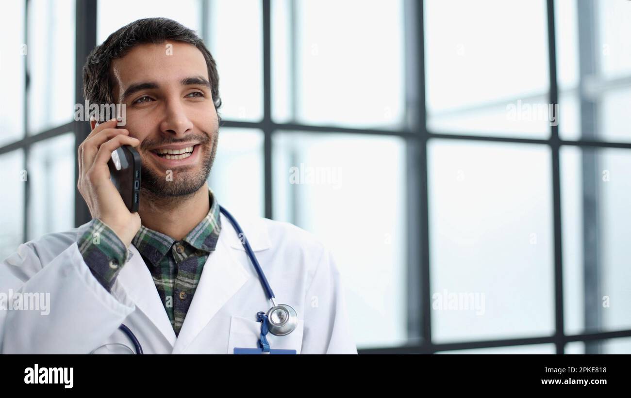 Phone call, male doctor doing a telehealth consultation in his office ...