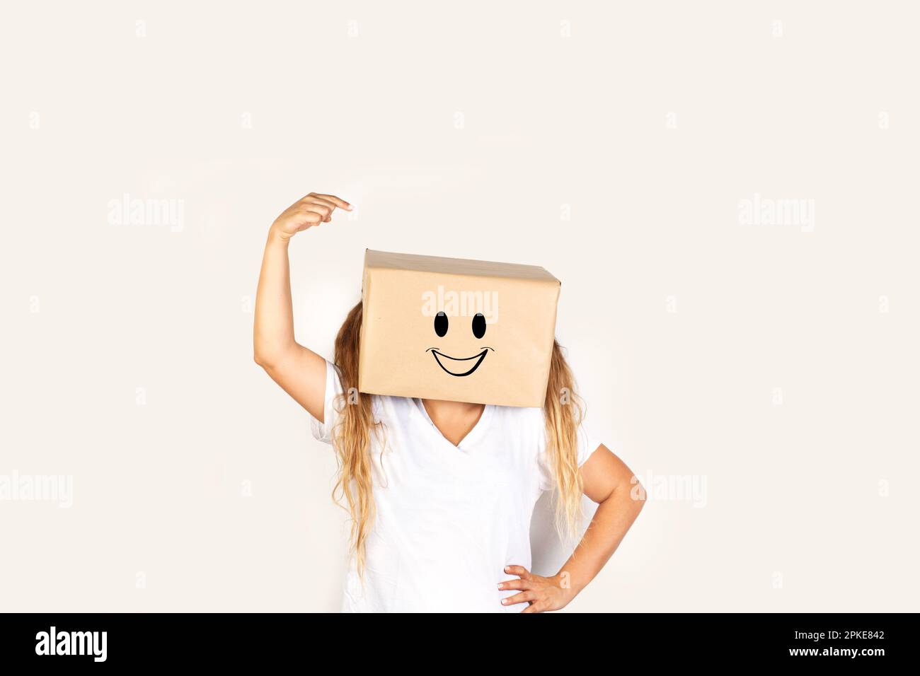 Woman with her head in a box with happiness gesture drawn on it and a ...