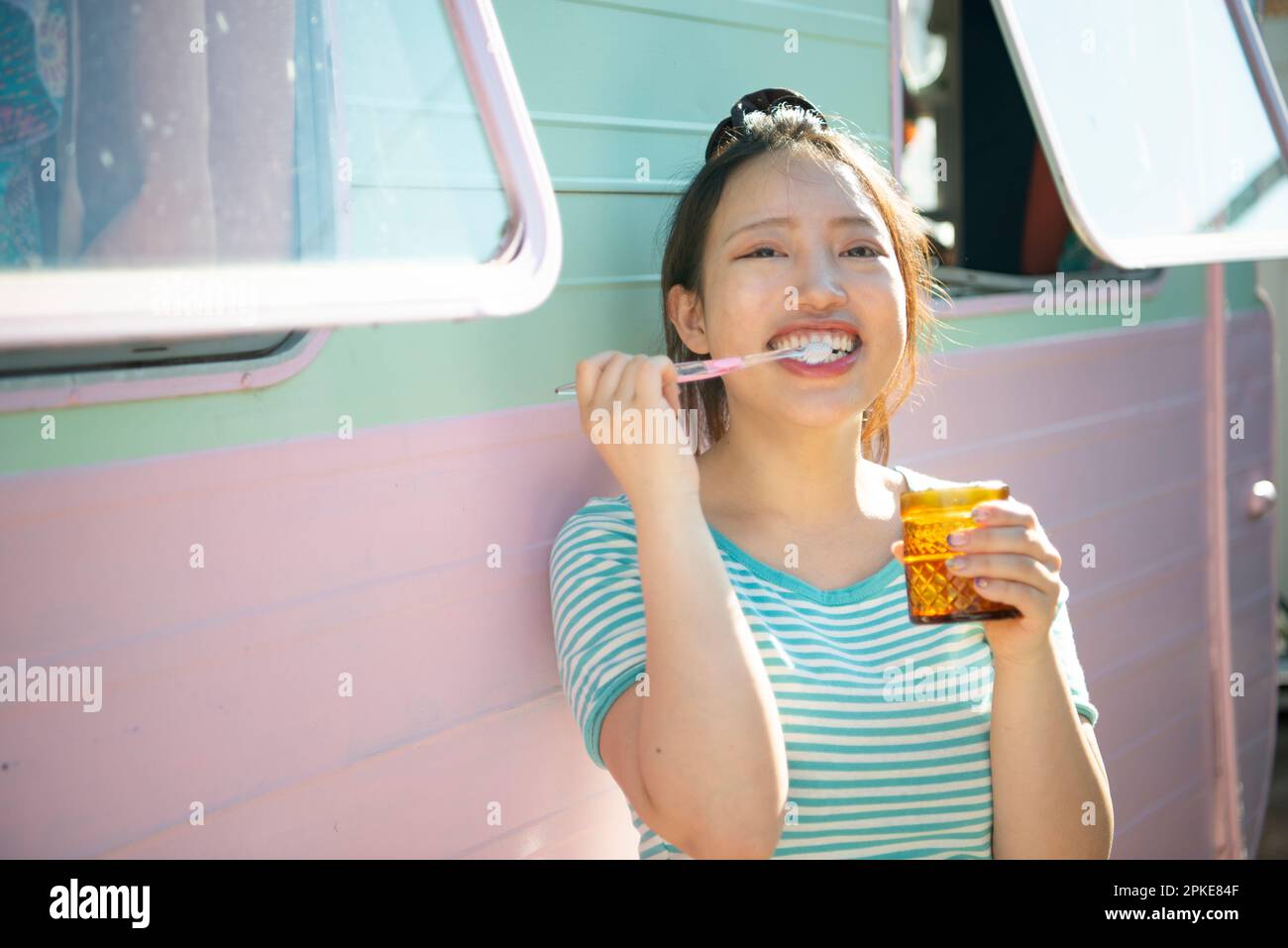 Woman brushing her teeth outside Stock Photo - Alamy