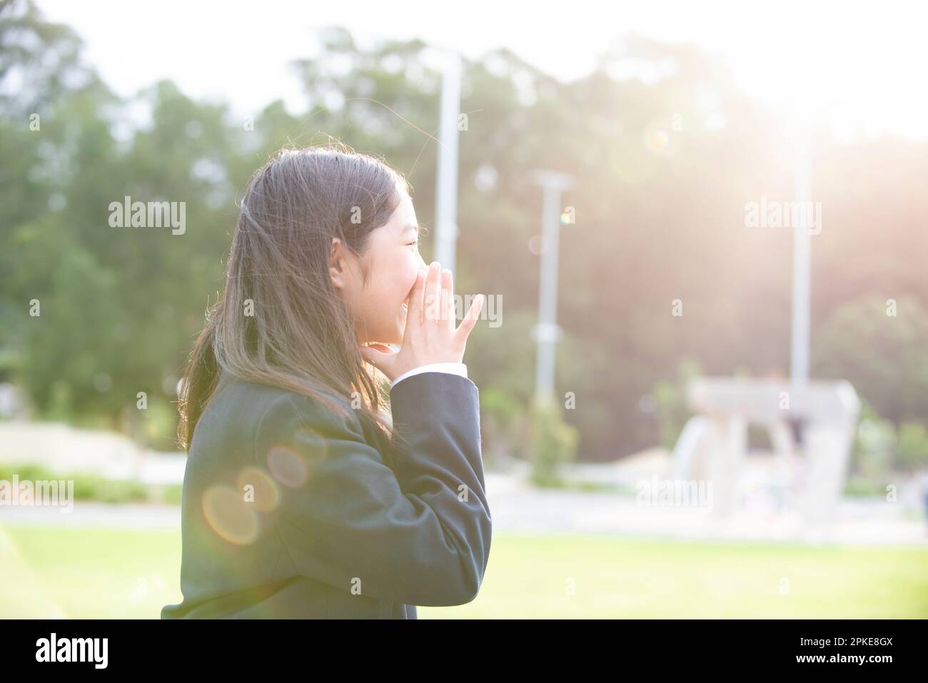 Female student in school uniform holding her hand and speaking out ...