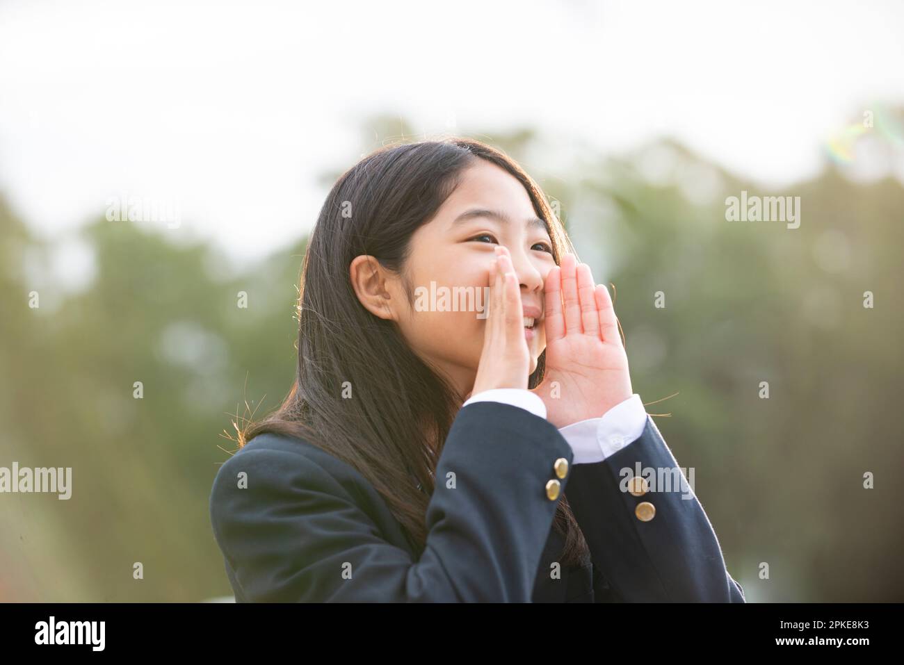 Female student in school uniform holding her hand and shouting Stock ...