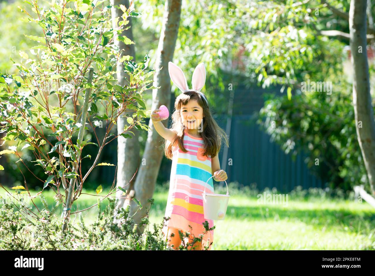 Girl doing Easter egg hunt Stock Photo - Alamy