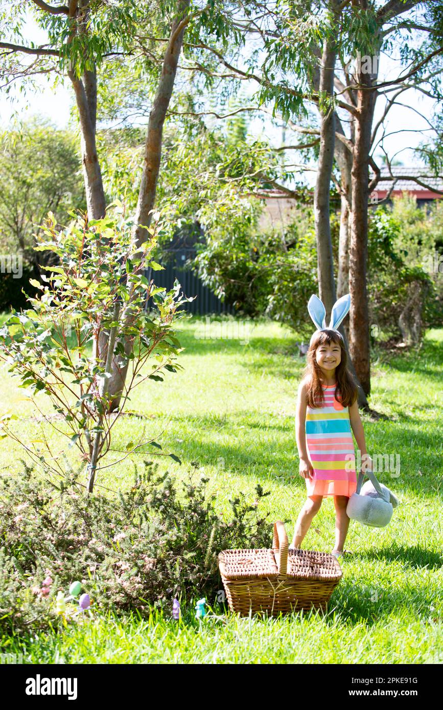 Girl doing Easter egg hunt Stock Photo - Alamy