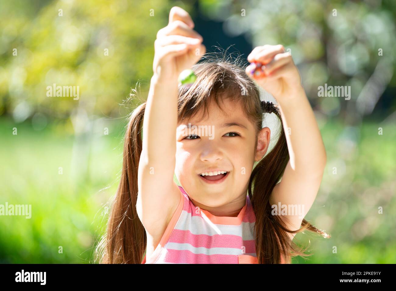 Girl laughing with egg chocolate Stock Photo - Alamy