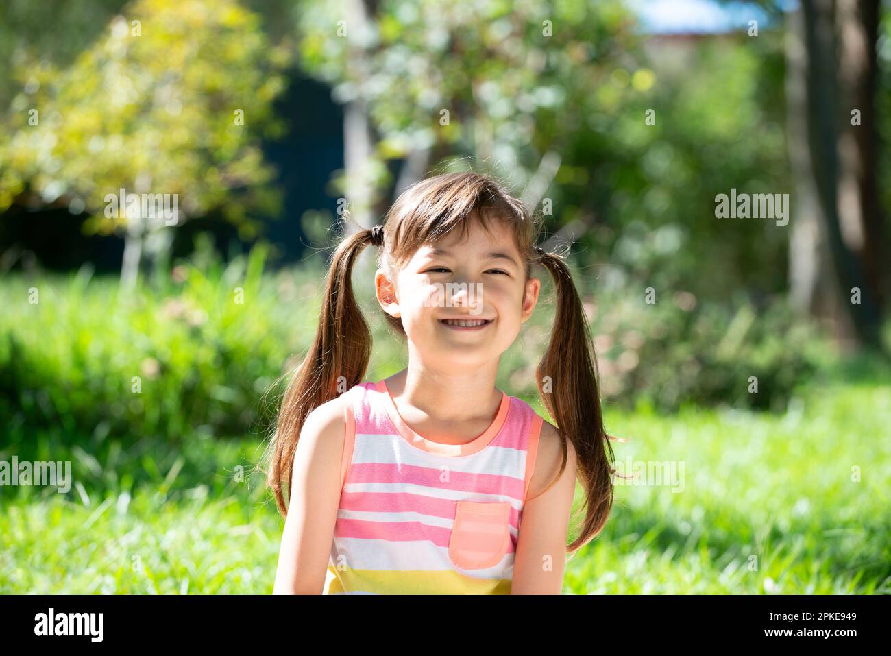 Girl laughing with twin tails Stock Photo - Alamy