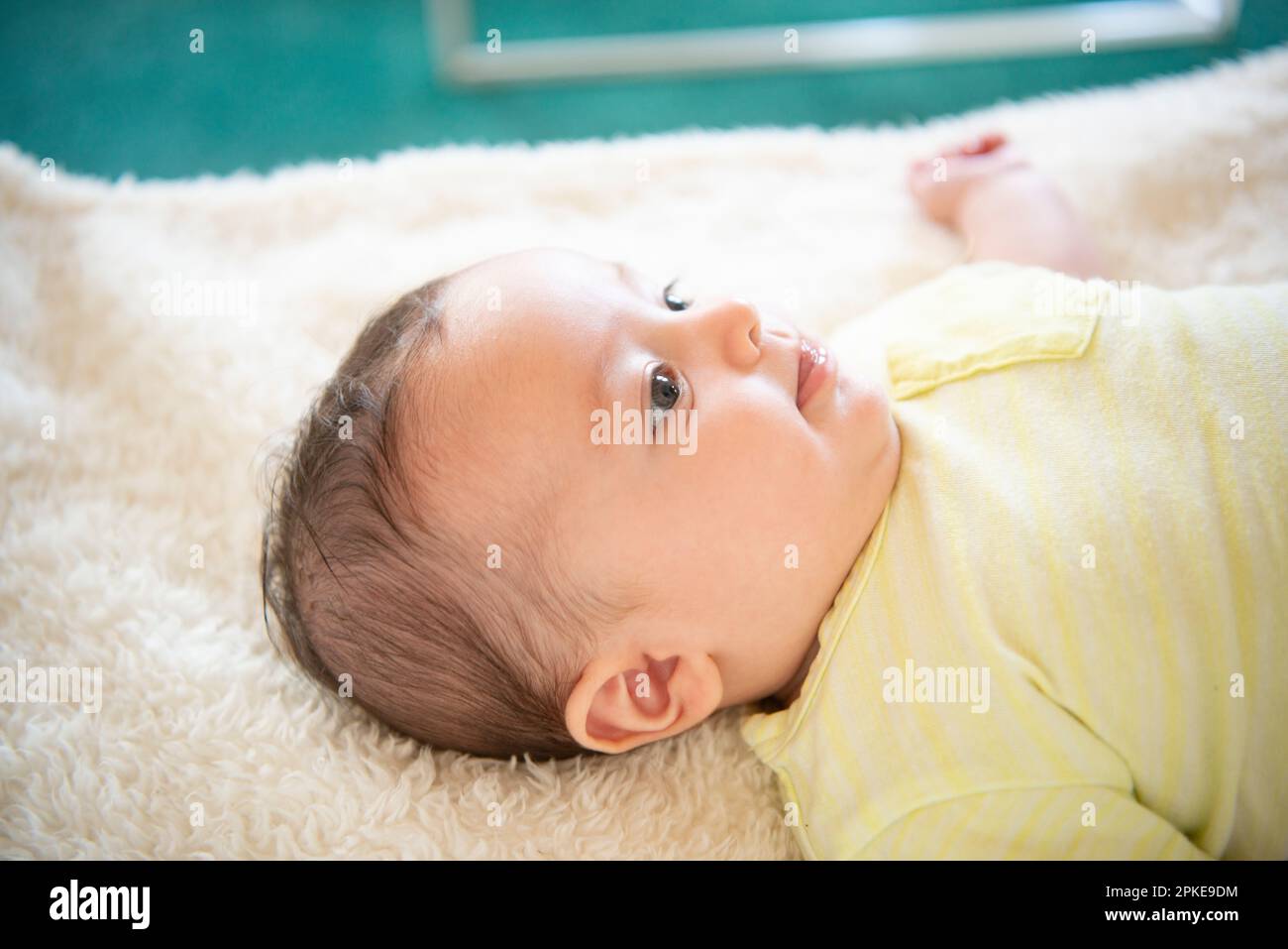 Baby on back looking far away Stock Photo - Alamy