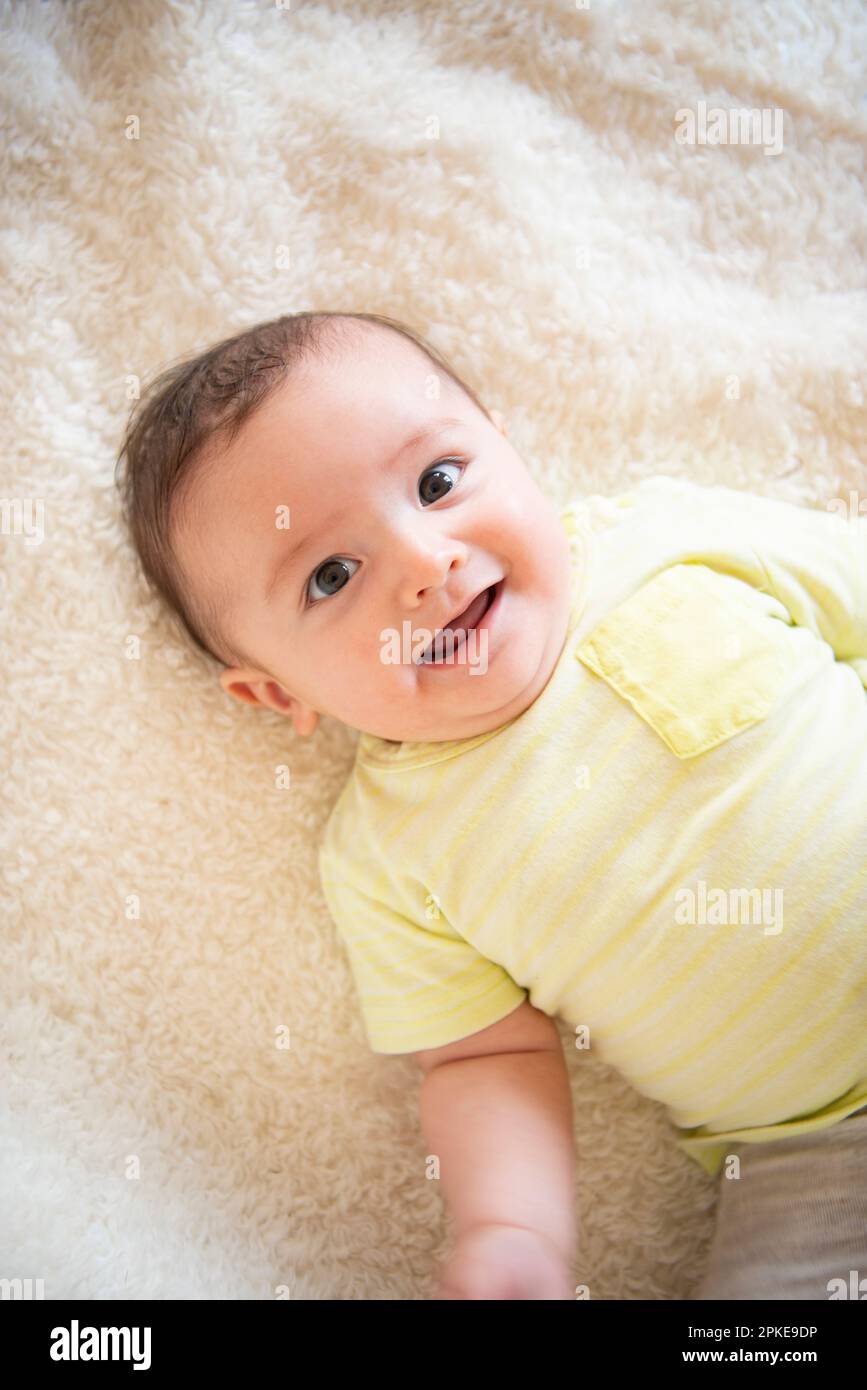 Baby on back laughing Stock Photo - Alamy