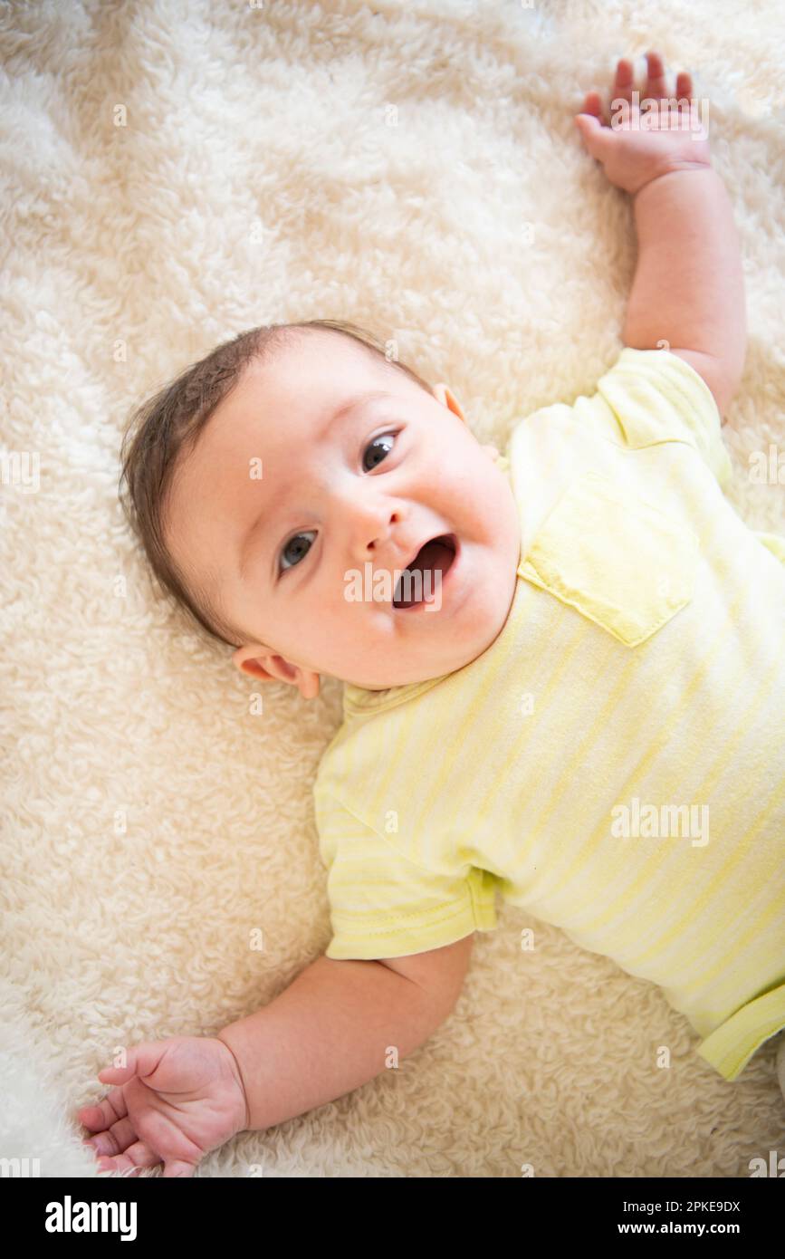 Laughing baby on back Stock Photo - Alamy