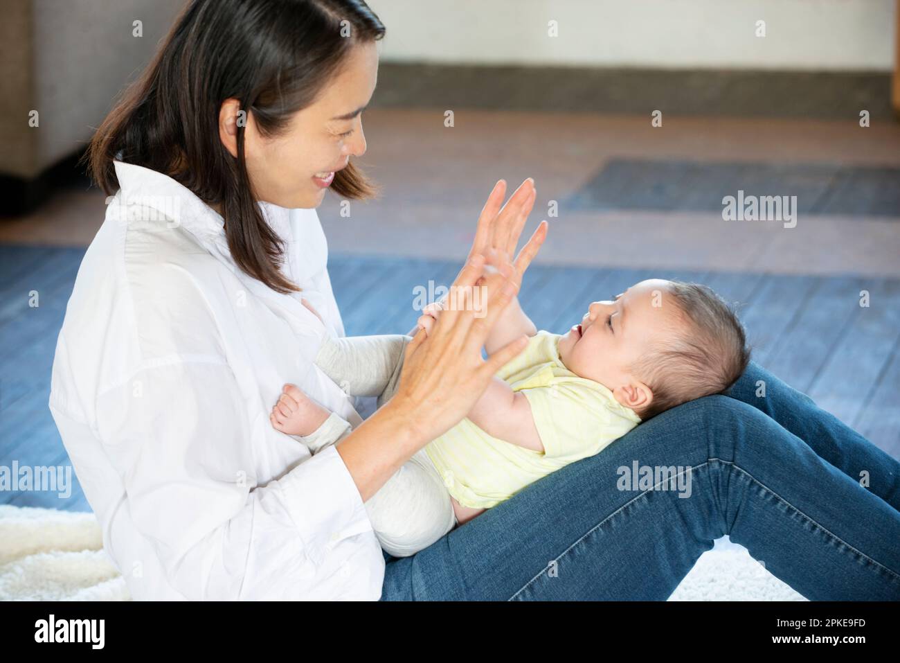 Mother nursing her baby in the house Stock Photo - Alamy