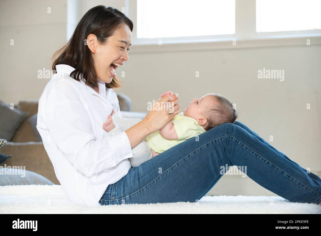 Mother nursing her baby in the house Stock Photo - Alamy
