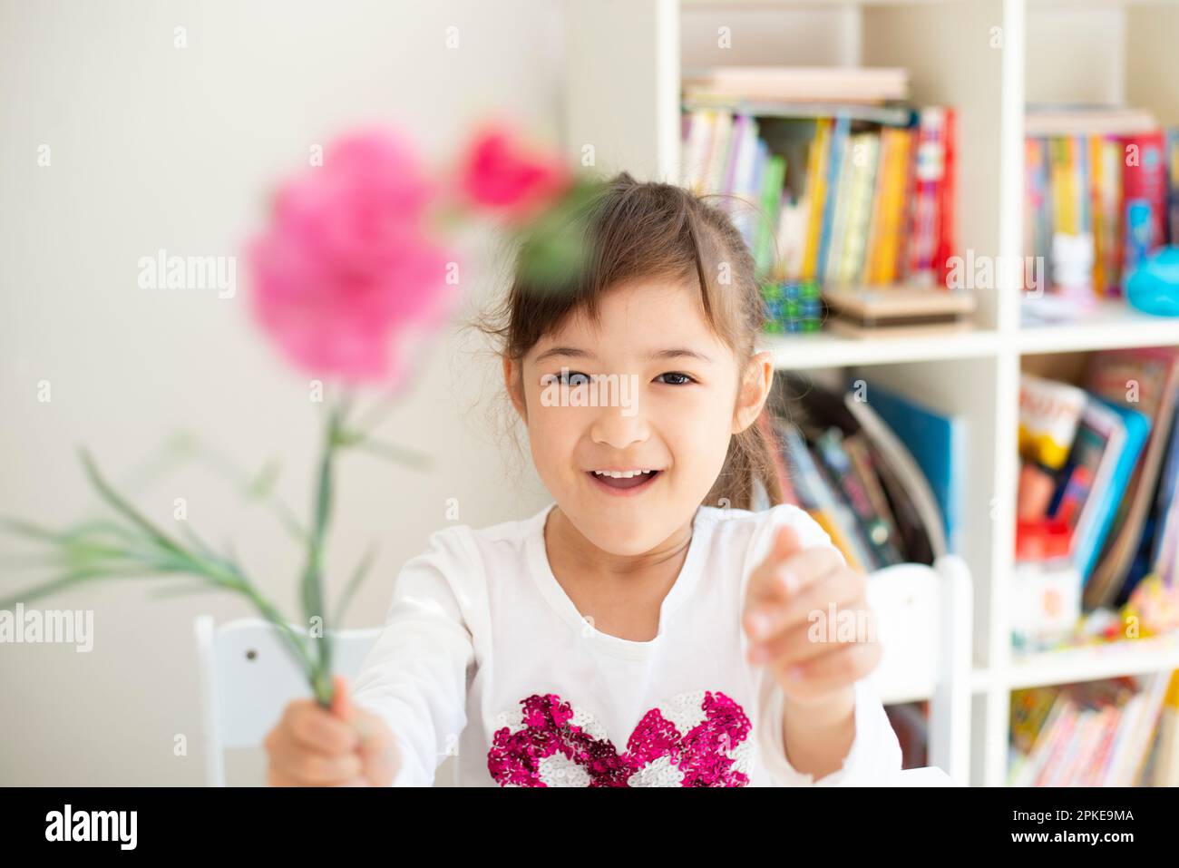 Child offering gift hi-res stock photography and images - Alamy
