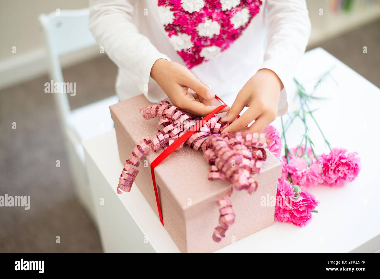 Child wrapping a present hi-res stock photography and images - Alamy