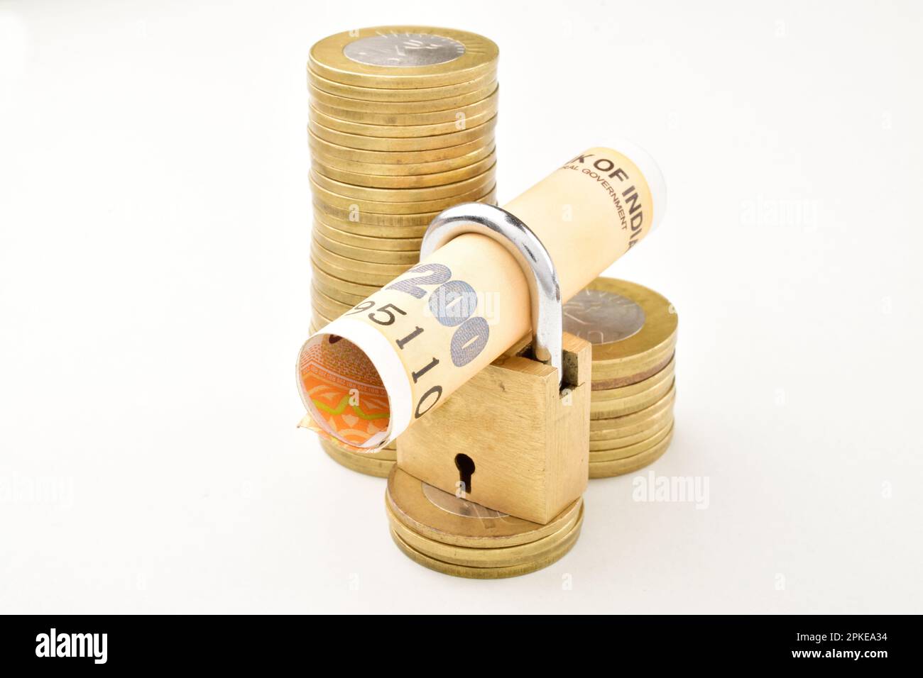 Padlock with coin and banknote isolated on white background, indian ...