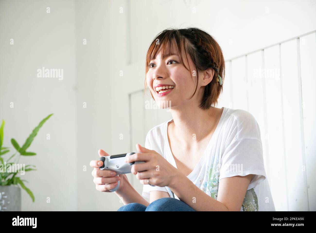 Woman with game controller Stock Photo - Alamy